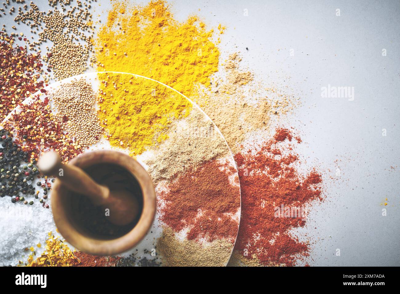 Mortar, pestle and spices in white background for powder, flavor and ...