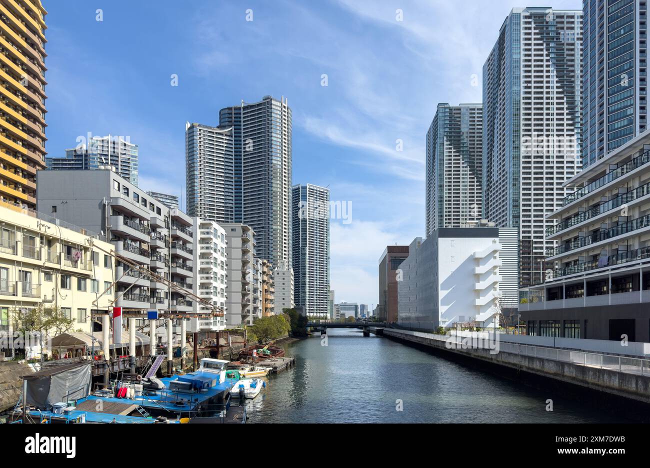 Tokyo city skyline, waterfront skyscrapers on blue sky background ...