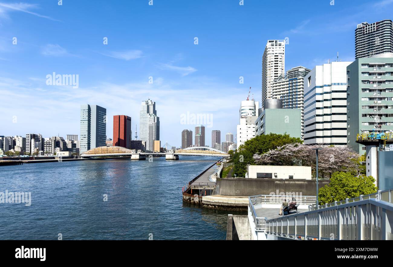 Tokyo city skyline, waterfront skyscrapers on blue sky background ...