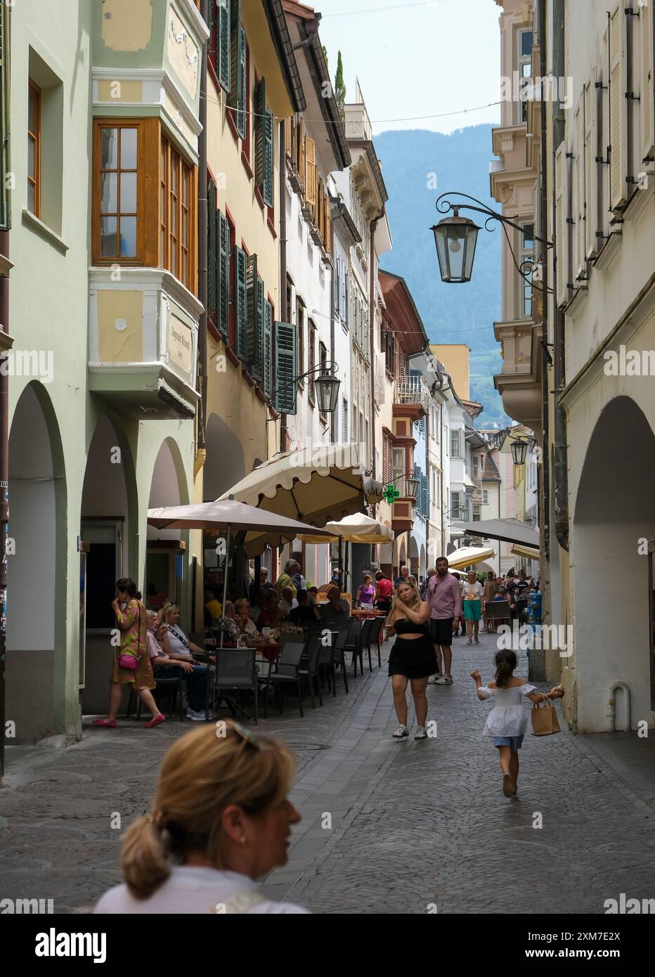 Merano, South Tyrol, Italy - Passers-by stroll through the Laubengasse ...