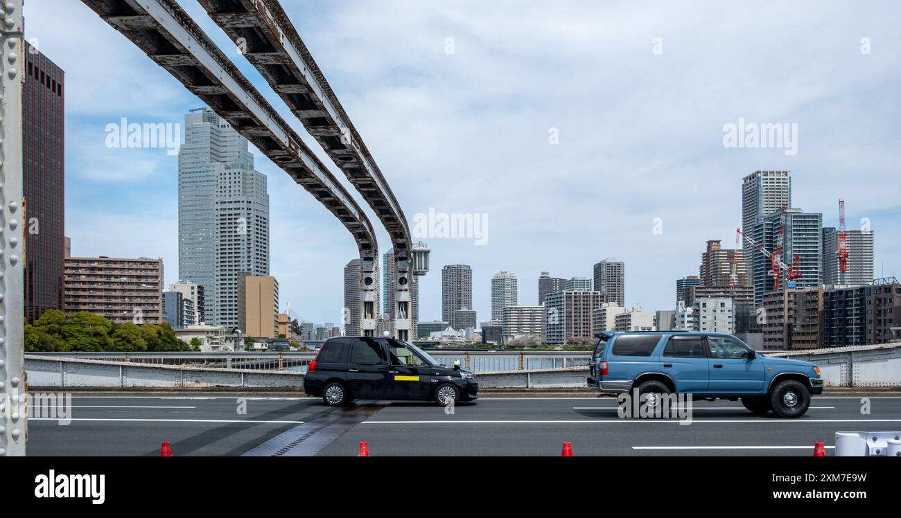 Tokyo city Japan. Cars on bridge over river canal, Modern high rise ...