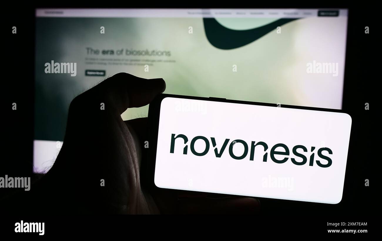 Person holding smartphone with logo of Danish biotechnology company ...