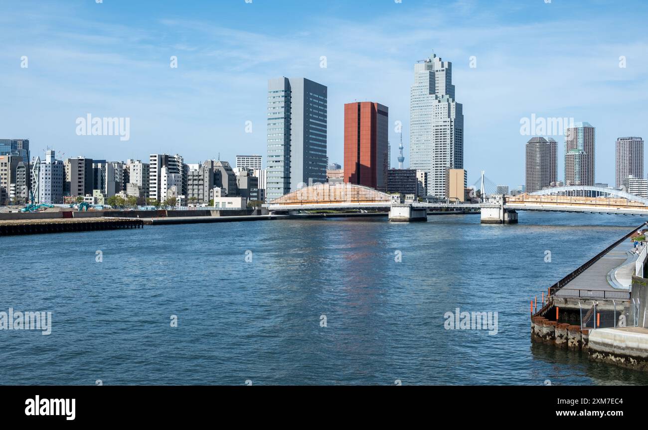 Tokyo city skyline, waterfront skyscrapers on blue sky background ...