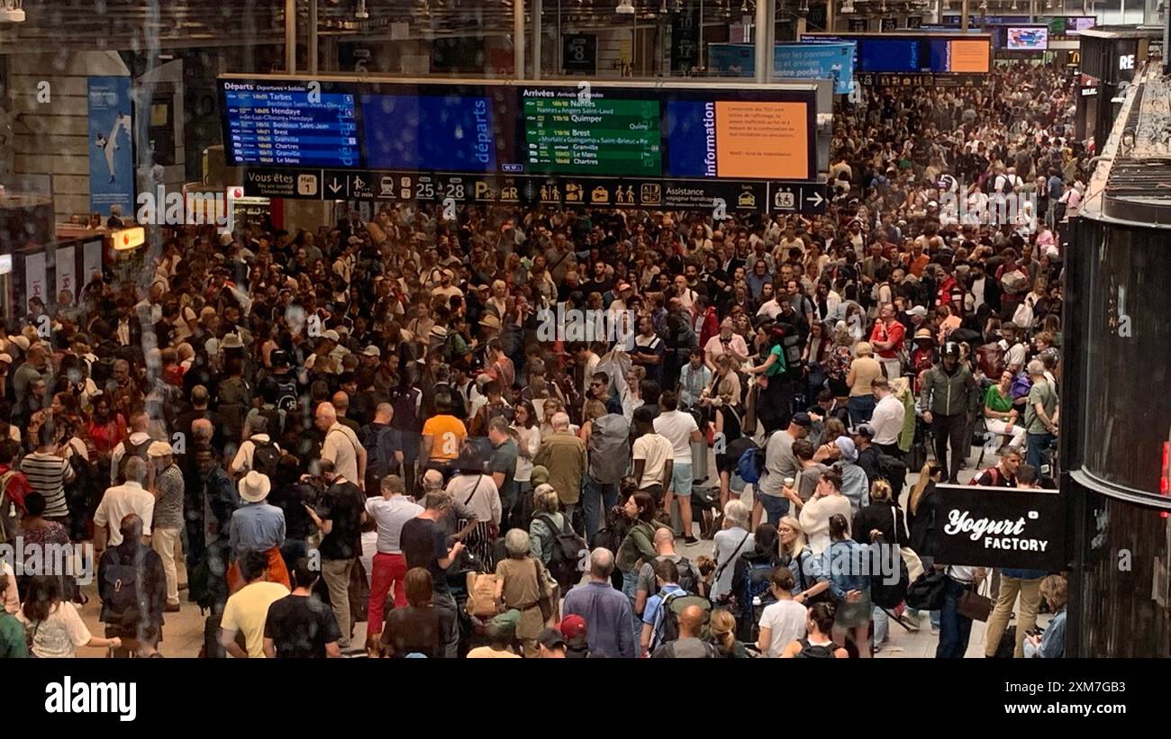 Passengers wait for their train departures at the Gare Montparnasse ...