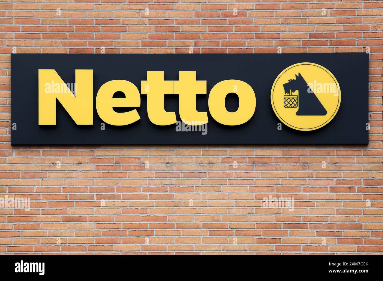 Netto sign on a wall. Netto is a Danish discount supermarket operating ...