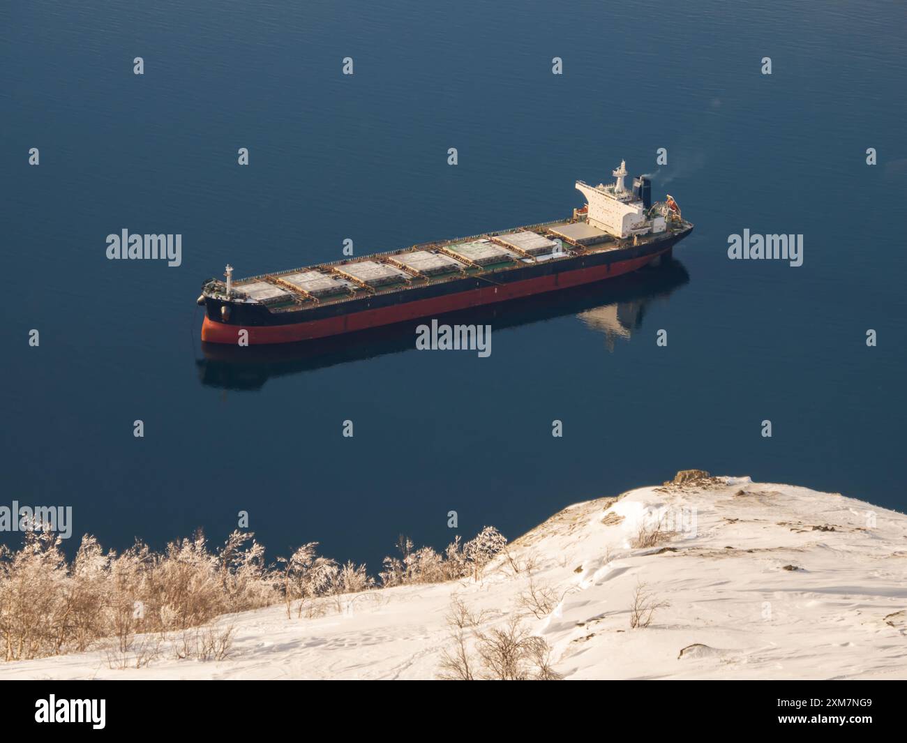 Aerial view of a cargo ship approaching port terminal, Narvik, Norway ...