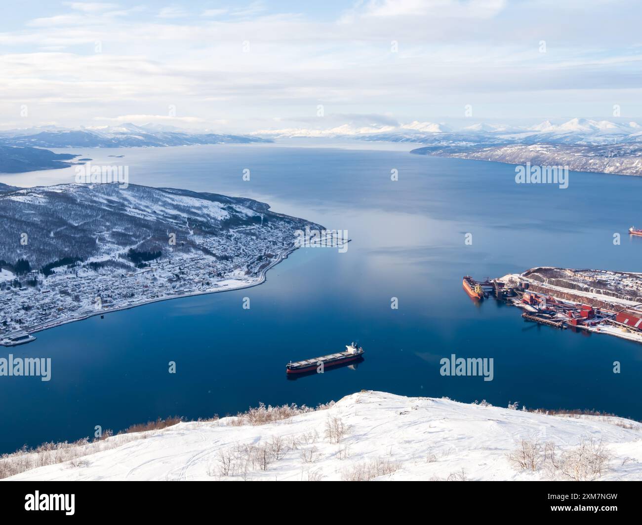 Aerial view of a cargo ship approaching port terminal, Narvik, Norway ...