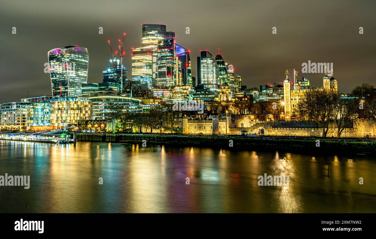 London Nightscape with skyscrapers of The City reflecting on the Thames ...
