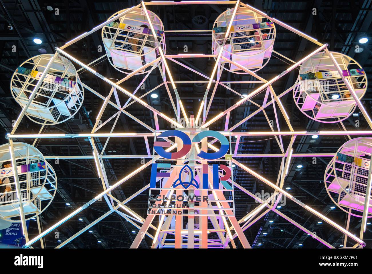 A ferris wheel with visitors who are sitting inside, with the name of ...