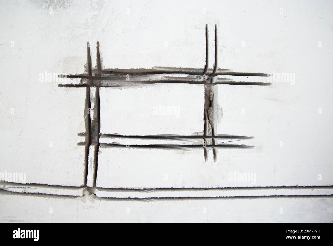 Grooves in a concrete wall for installing new socket boxes for sockets ...