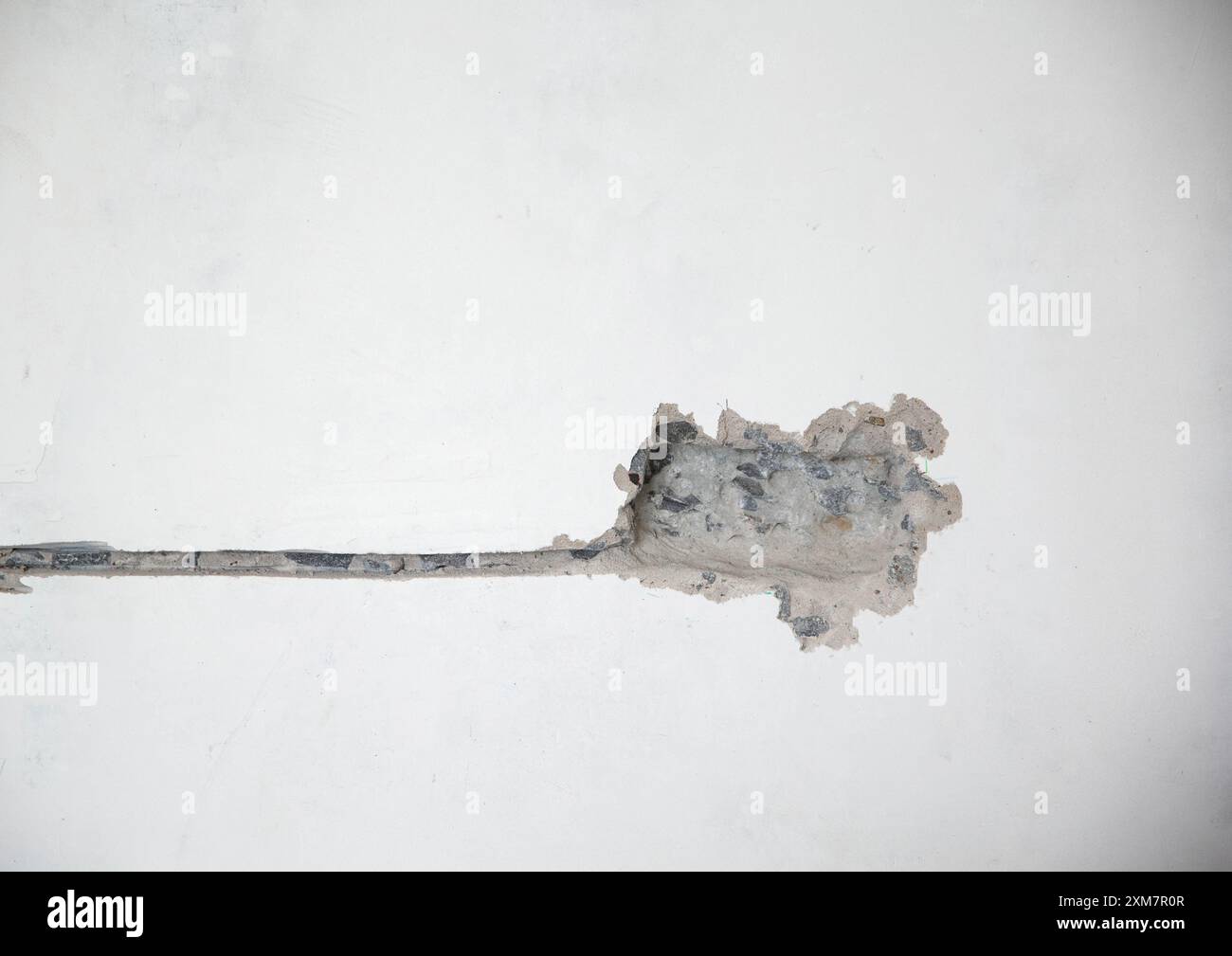 A hole in a concrete wall for installing new sockets during renovations ...