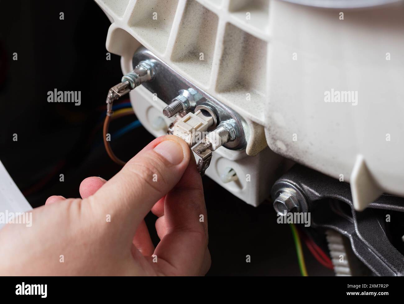 The hand of the master disconnects the electrical chip from the ...