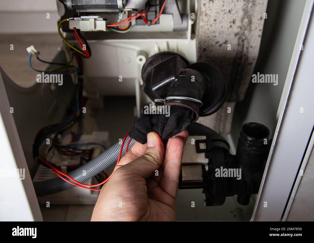 The rubber drain pipe and drain pump are clogged with clothes in the ...