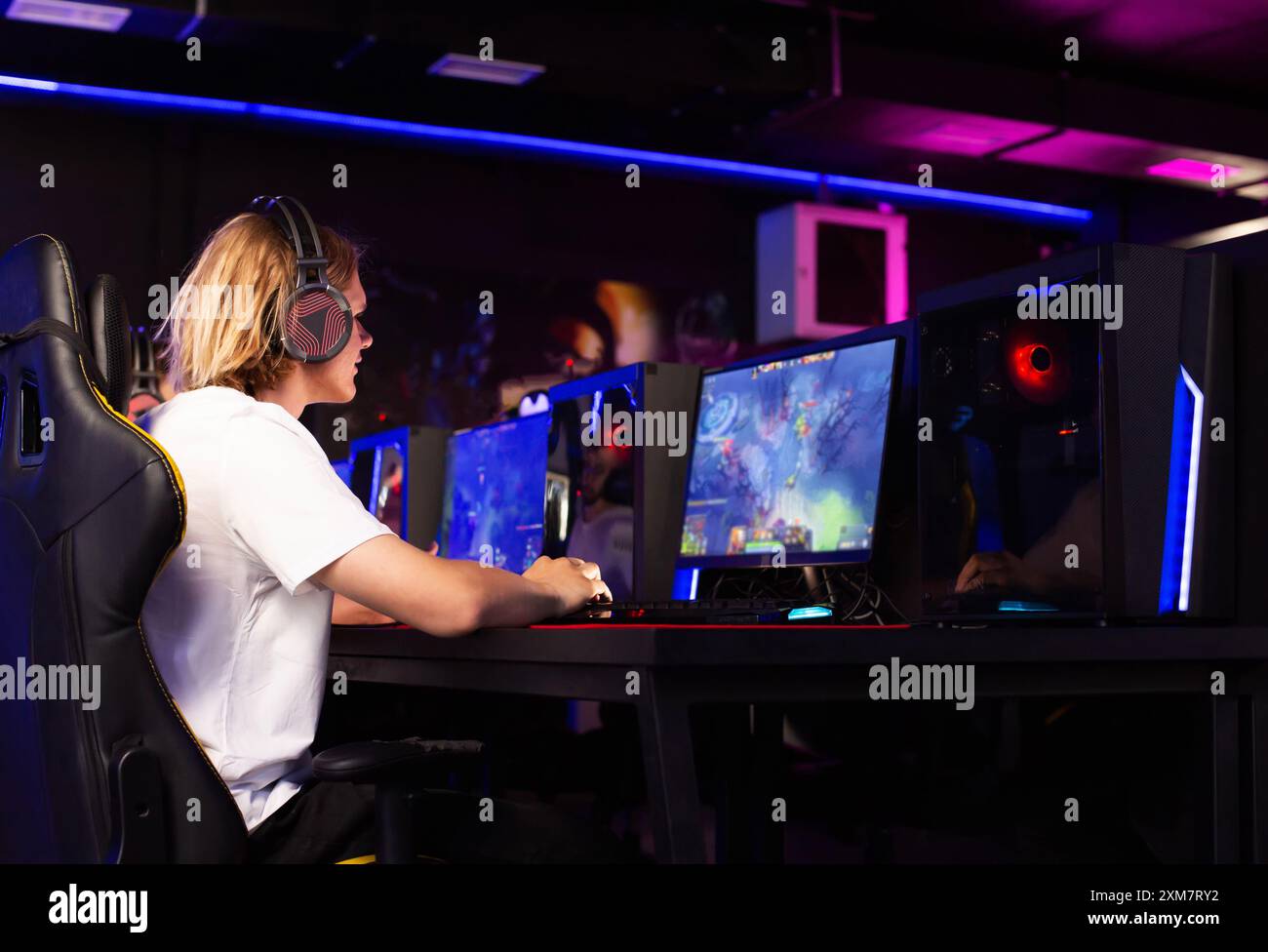 Gamer plays PvP shooter battle royale video game on PC at computer club ...