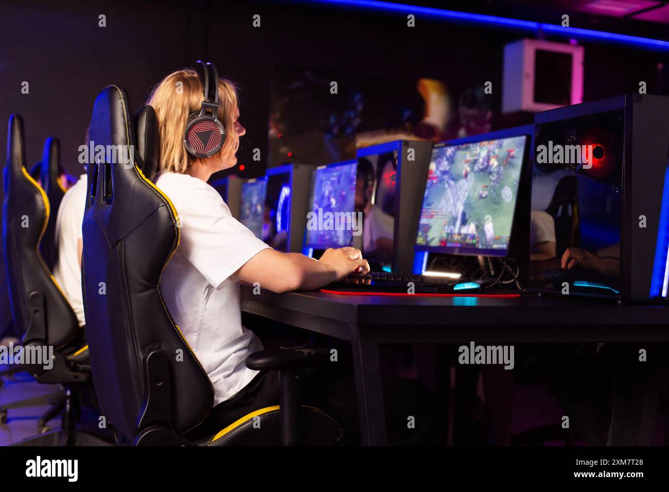 Gamer plays PvP shooter battle royale video game on PC at computer club. Skill. Professional ...