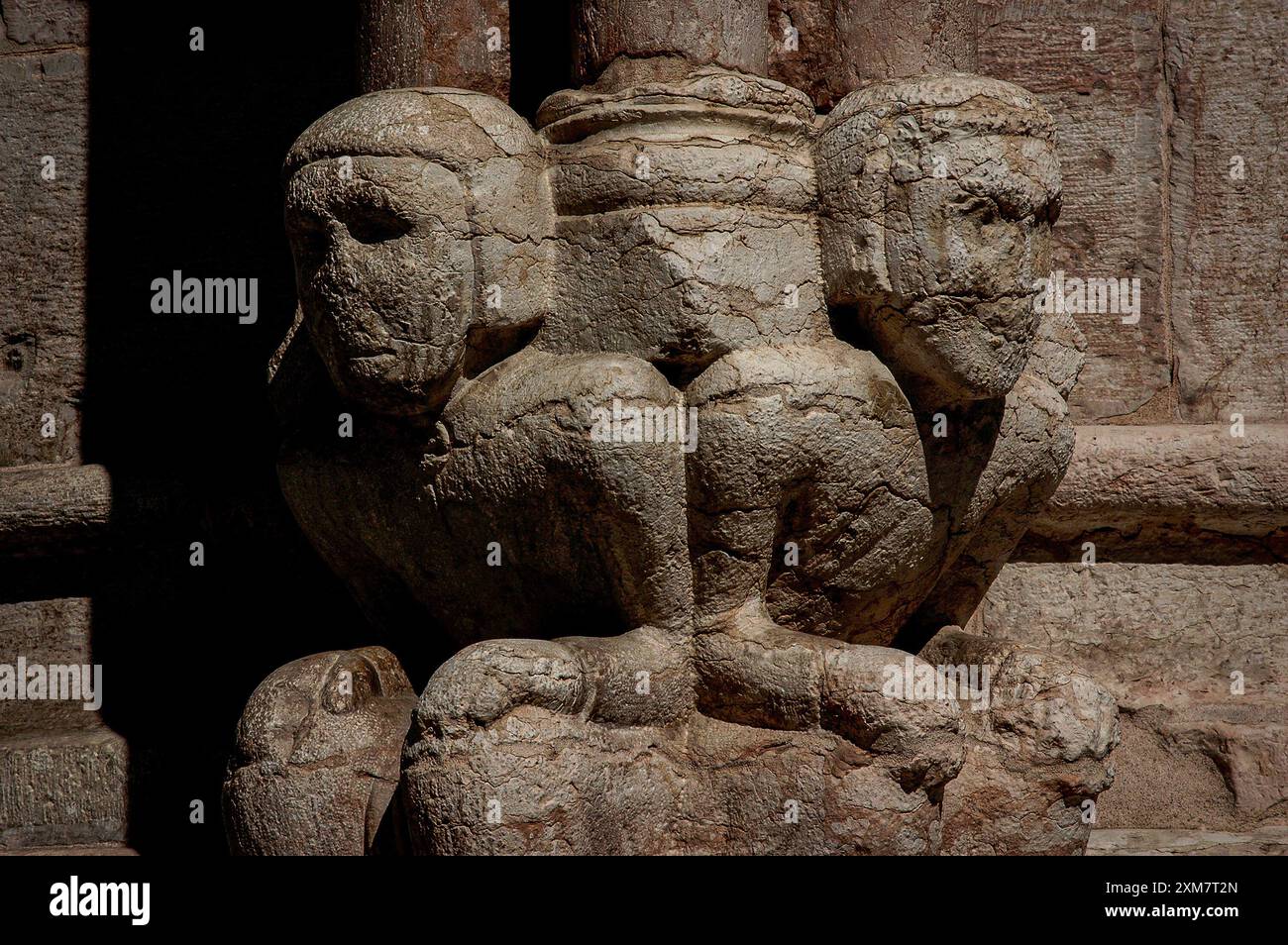 Two of three seated figures sculpted in marble at the base of a column ...