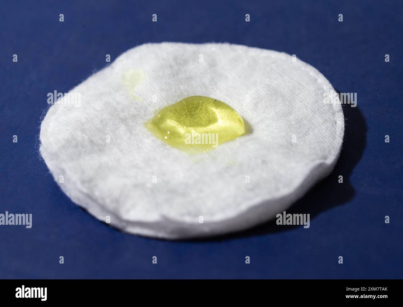 Medical healing ointment of yellow color on a white cotton pad and a ...