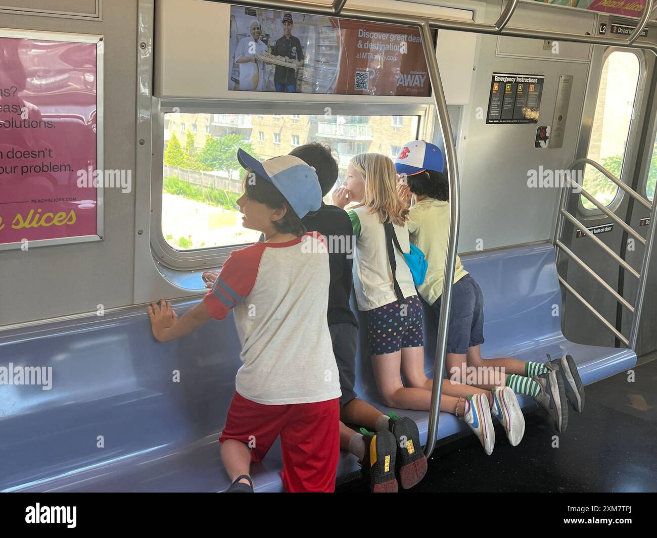 KIds look out above ground subway window on their way to Coney Island ...
