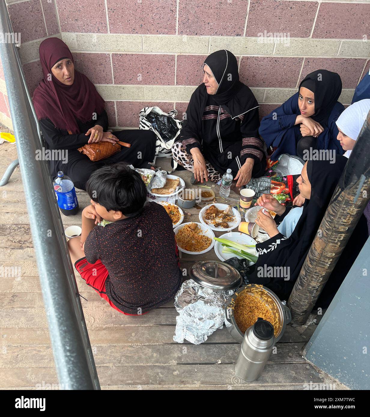 Muslim immigrant family finds a corner on the boardwalk at Coney Island ...