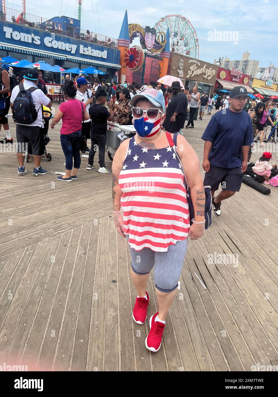 Woman on Independence Day, July 4th attire on the boardwalk at Coney ...