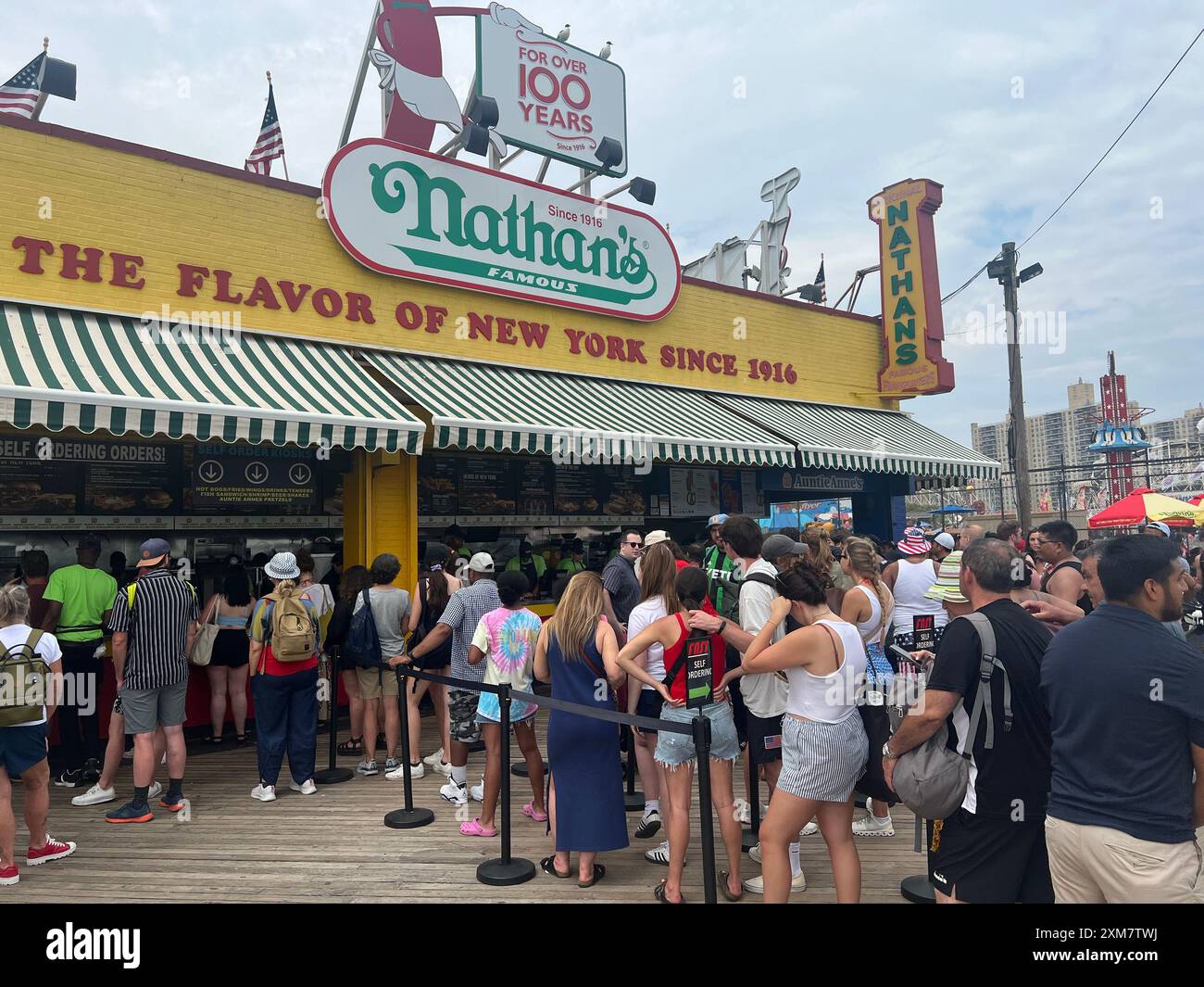 Peopole line up for food at the Famous Nathan's Hot Dogs on the ...