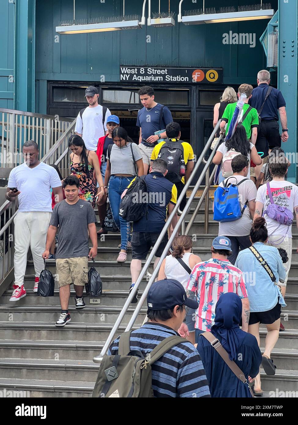 People enter and exit the busy West 8th Street subway station by the ...