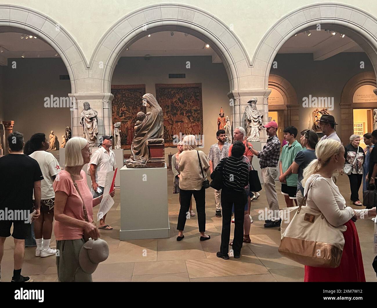 Museum goers in the medieval galleries at the MET viewing the limestone ...