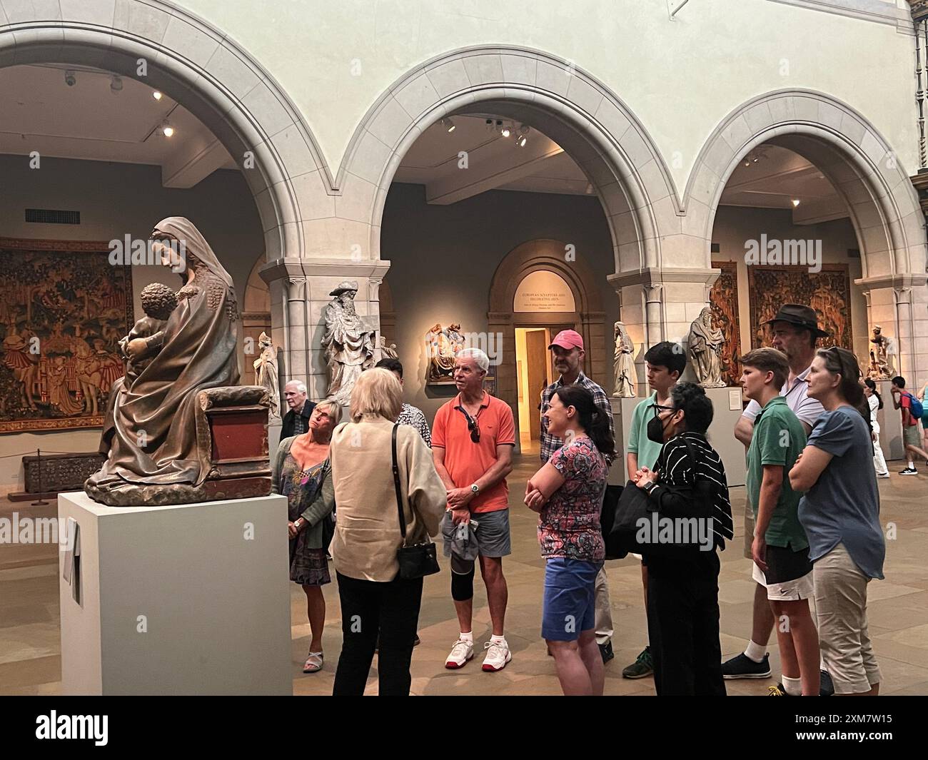 Museum goers in the medieval galleries at the MET viewing the limestone ...
