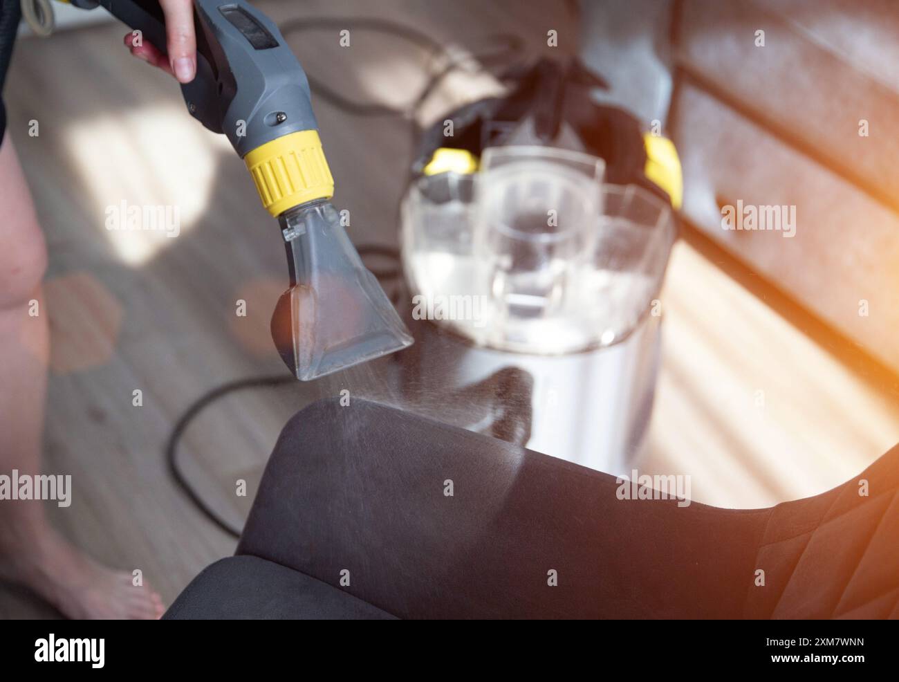 Dry cleaning services, washing and cleaning gray fabric chairs with a ...