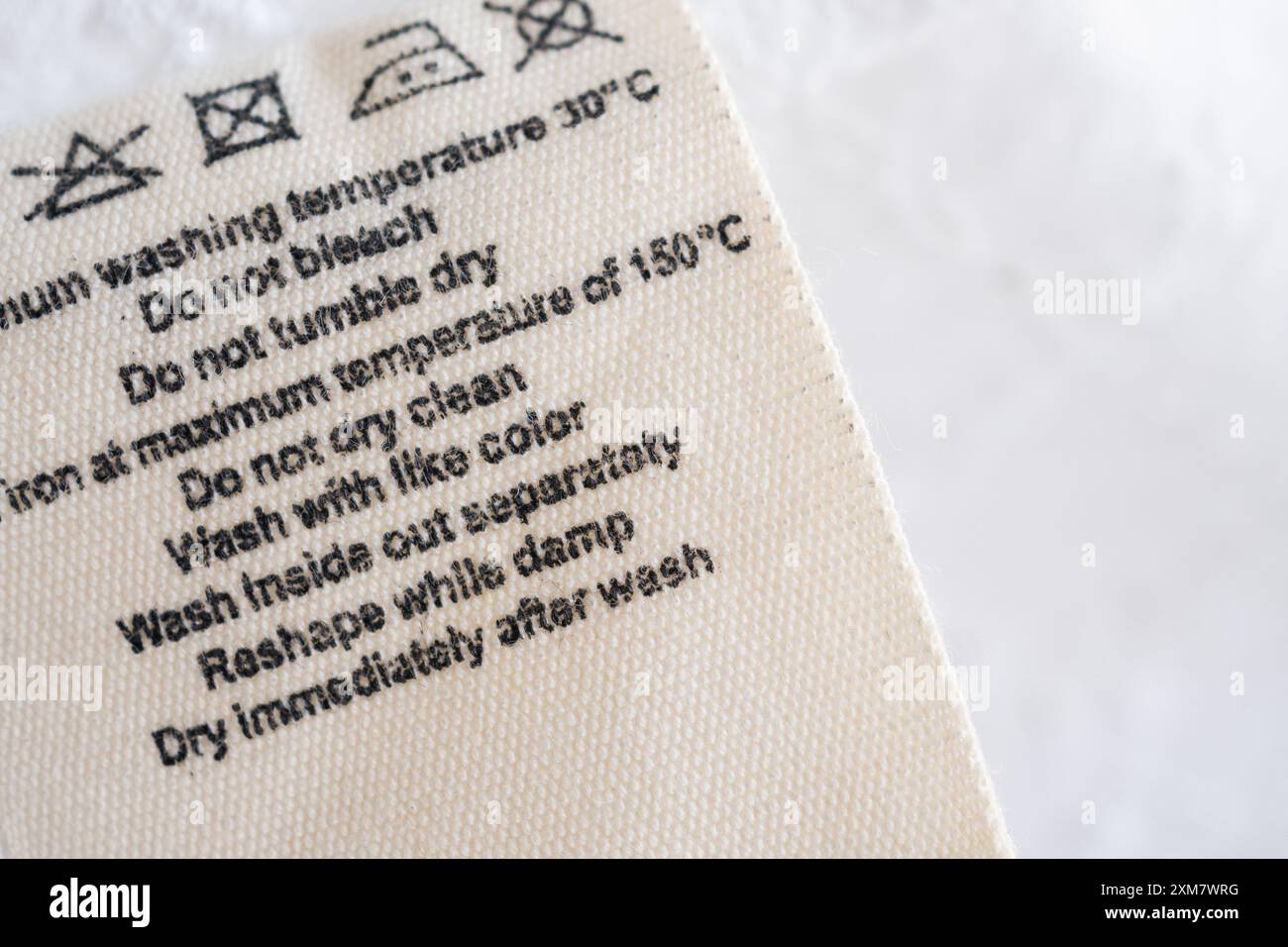 laundry care washing instructions clothes label on fabric texture ...