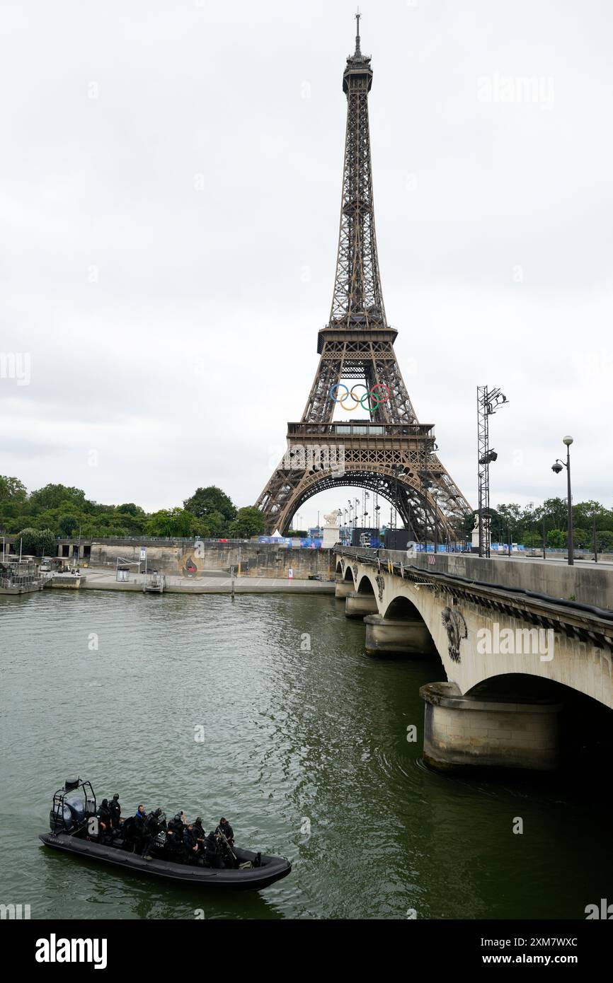 Special forces ride boats along the Senne River with the Eiffel Tower ...