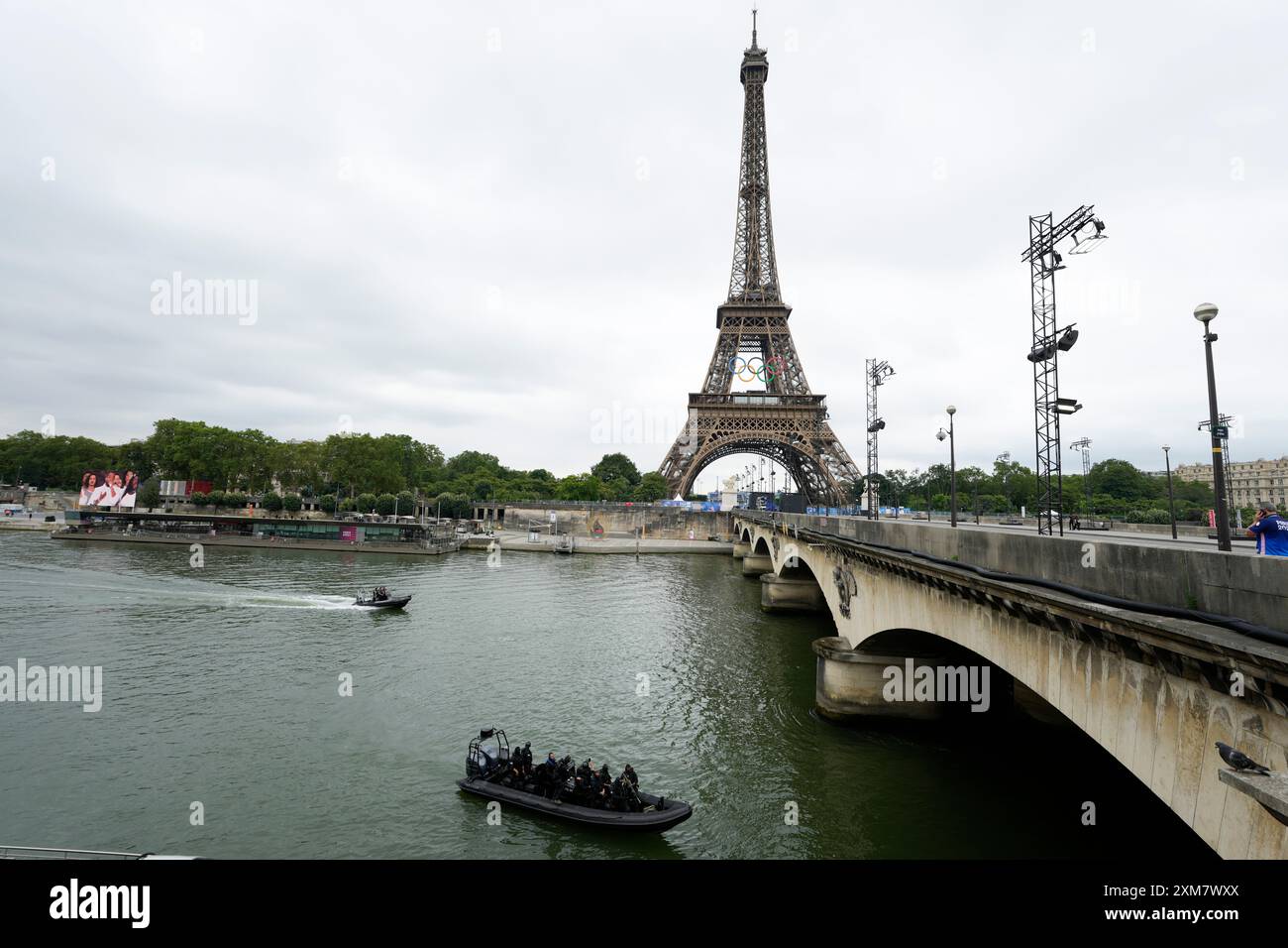 Special forces ride boats along the Senne River with the Eiffel Tower ...