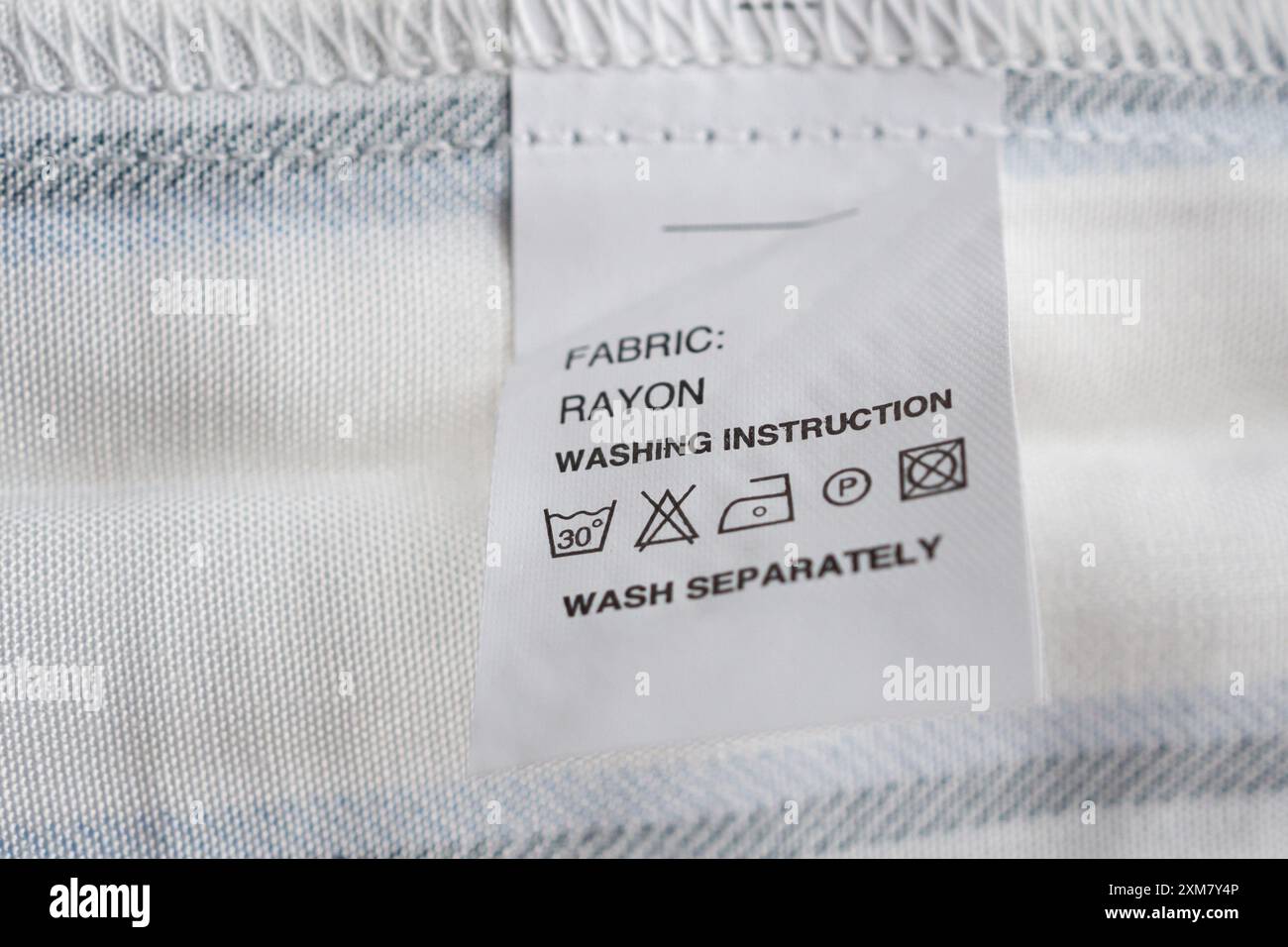 White laundry care washing instructions clothes label on rayon shirt ...