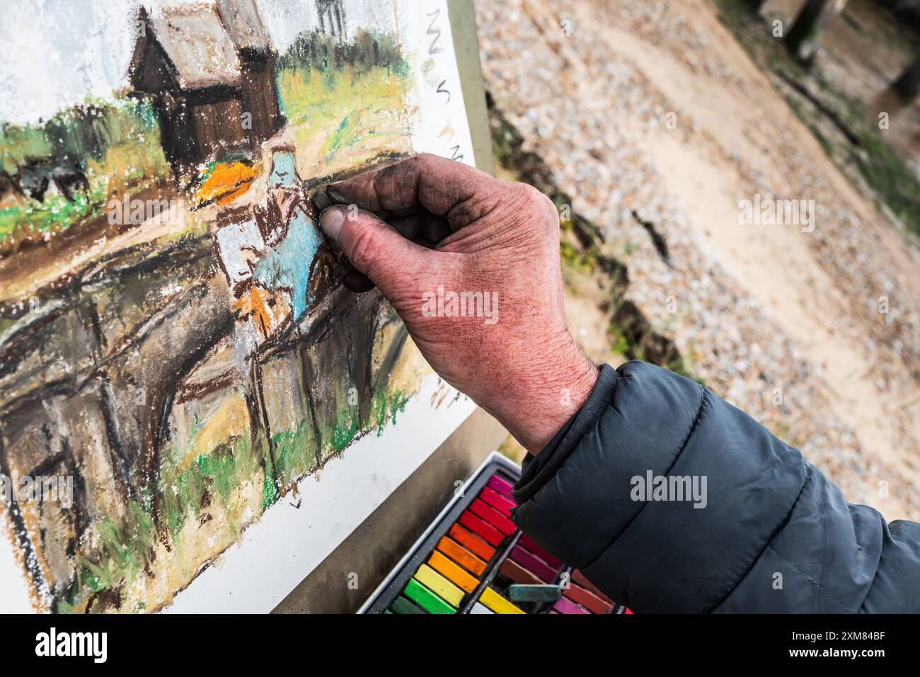 Artist's hand sketching a pastel crayon picture - close up of hand ...