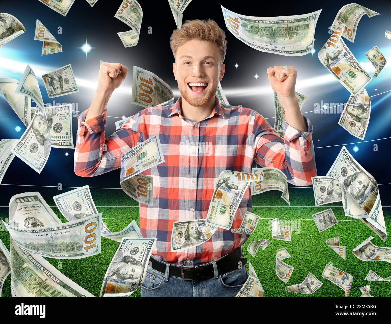 Happy man under money shower at stadium Stock Photo - Alamy