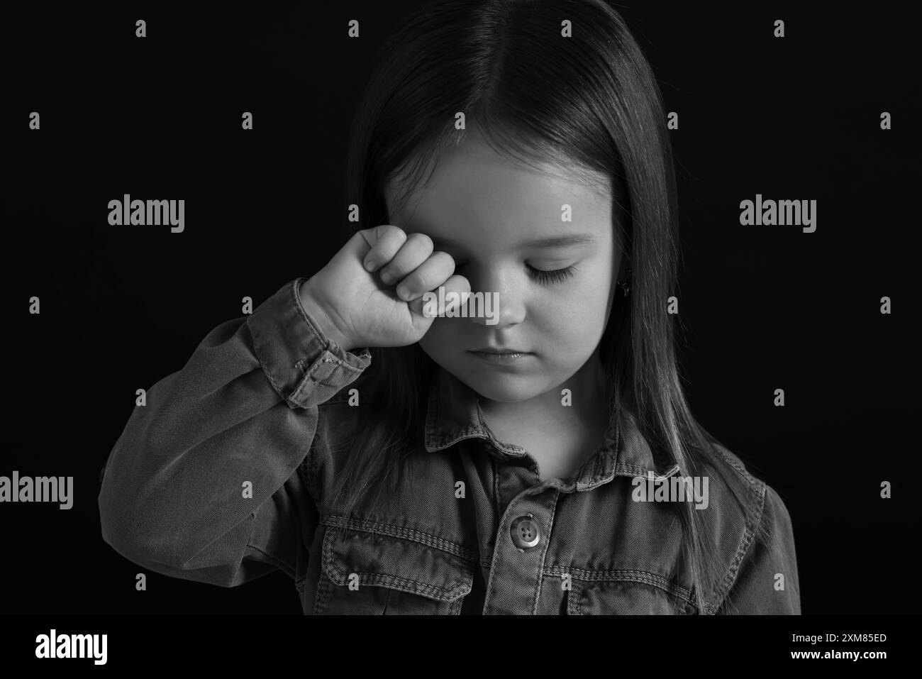 Portrait of sad girl on dark background, closeup. Black and white ...