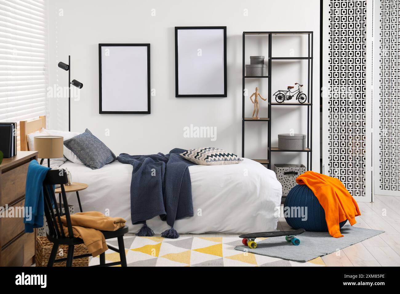 Teen's room interior with modern furniture and empty frames on wall ...