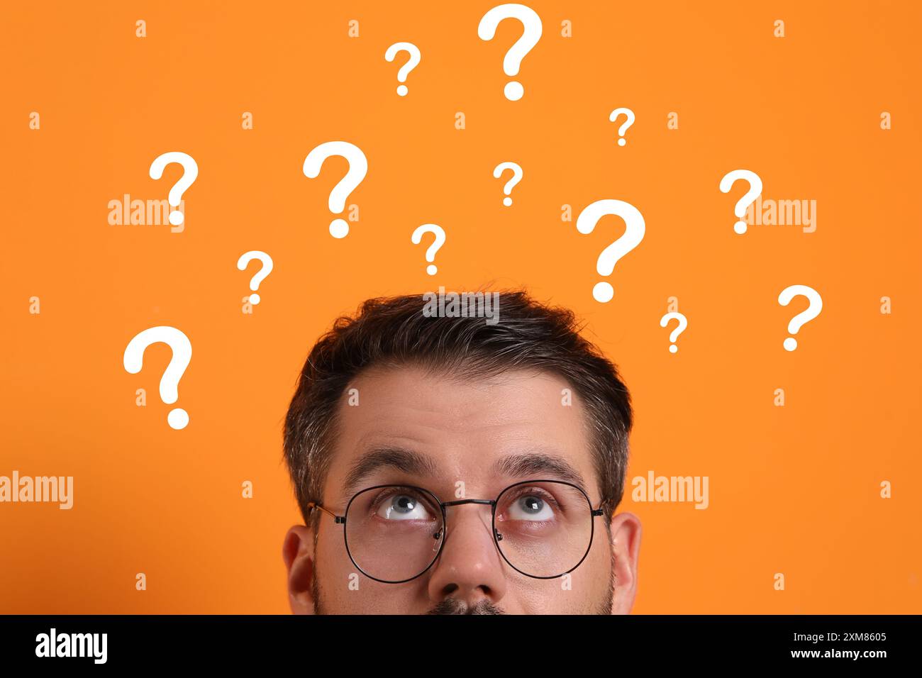 Man and question marks on orange background, closeup Stock Photo - Alamy
