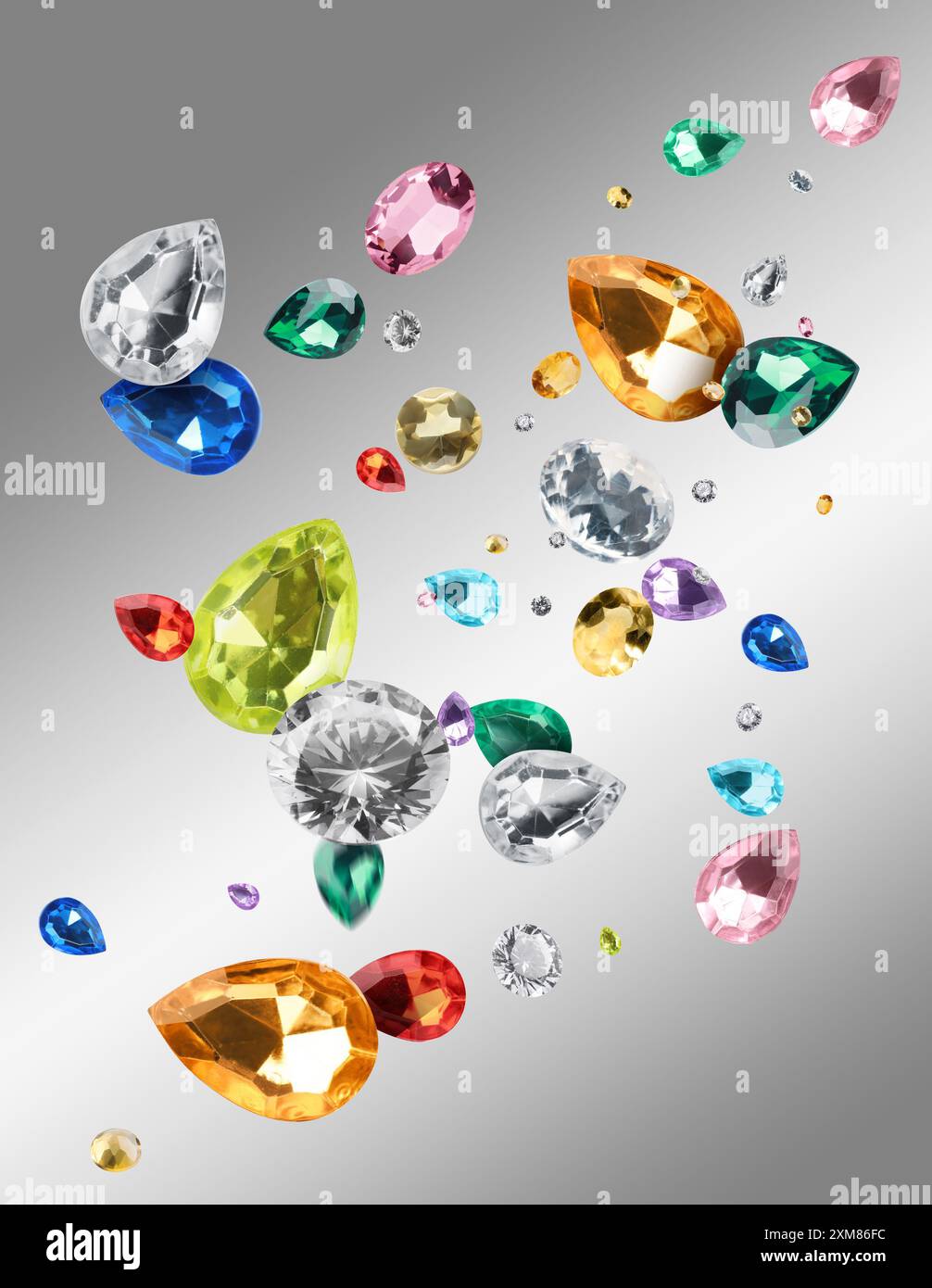 Many shiny gemstones in air on grey gradient background Stock Photo - Alamy
