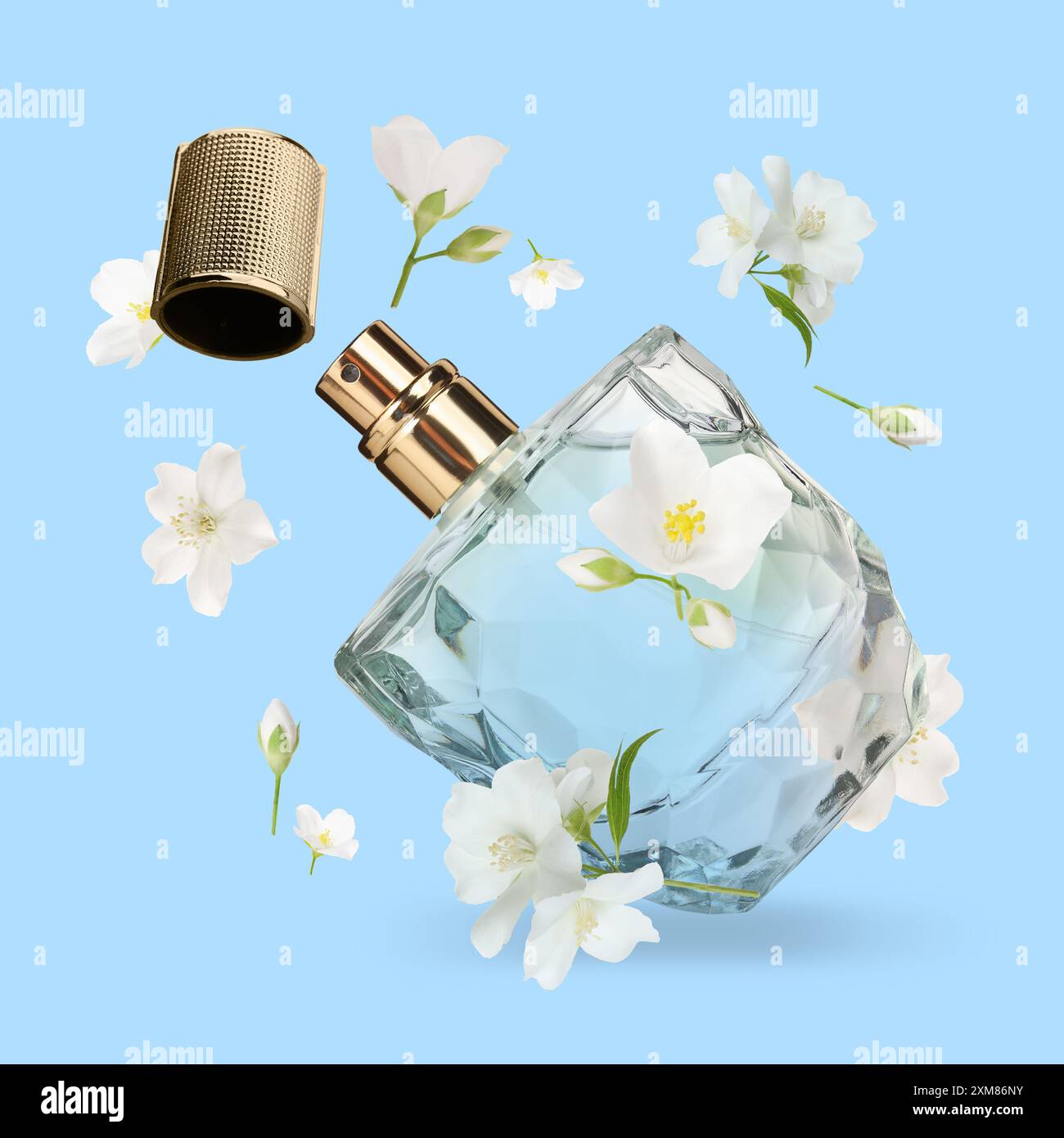 Bottle of floral perfume and jasmine flowers in air on light blue ...