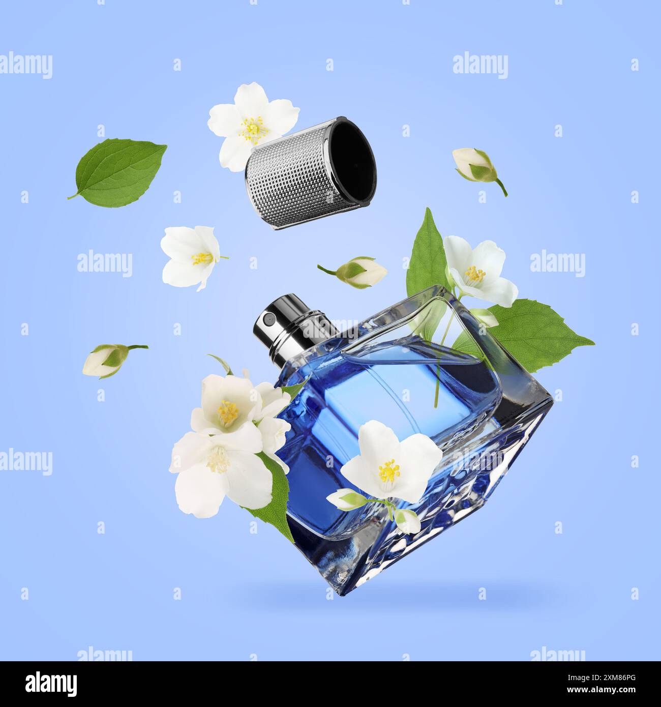 Bottle of floral perfume and jasmine flowers in air on light blue ...