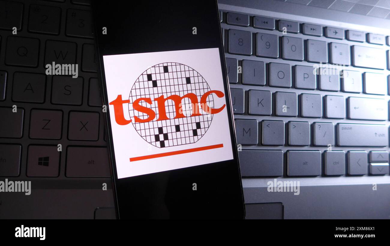 In this photo illustration, TSMC logo is displayed on a smartphone with ...