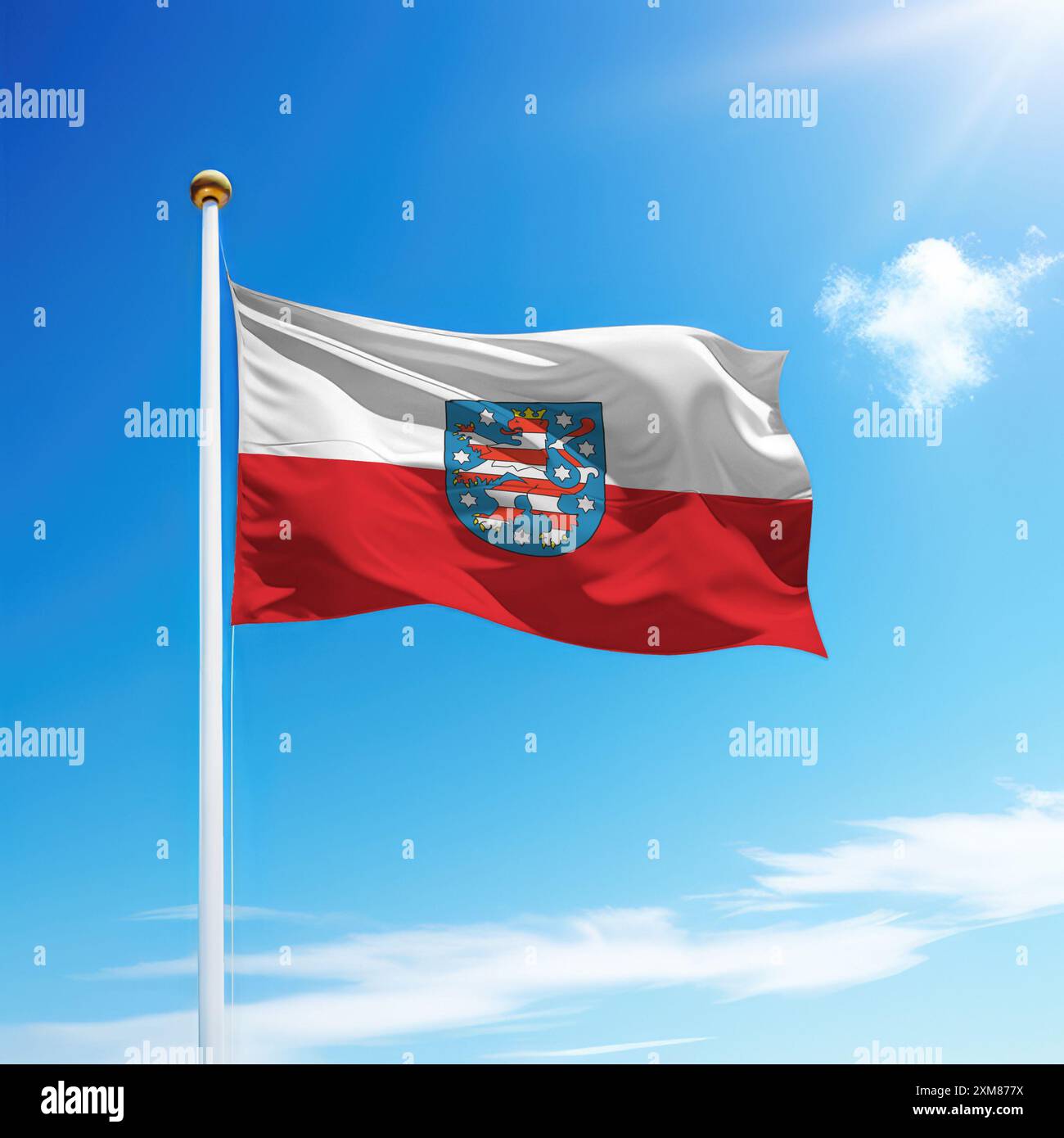 Waving flag of Thuringia is a state of Germany on flagpole with sky ...