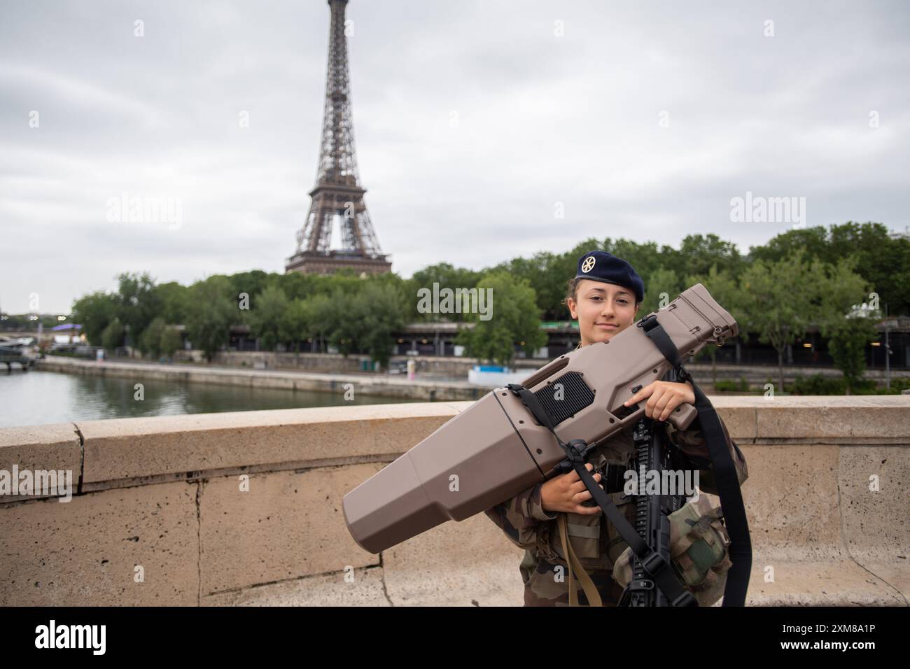 A member of Operation Sentinelle is seen on guard at the River Seine ...