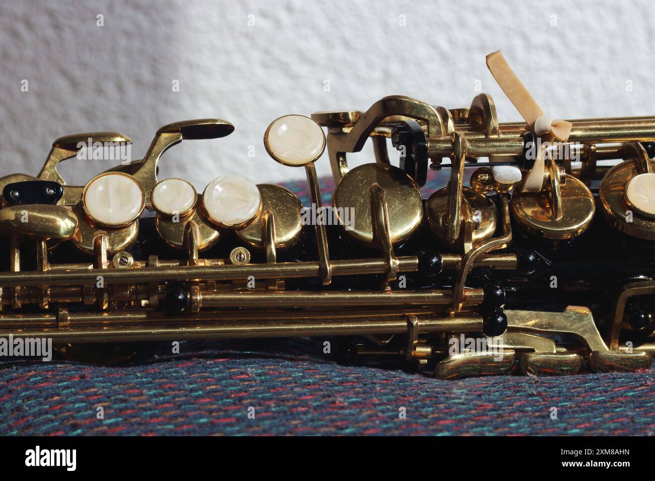 Close-up of the middle section of a black colored straight saxophone ...