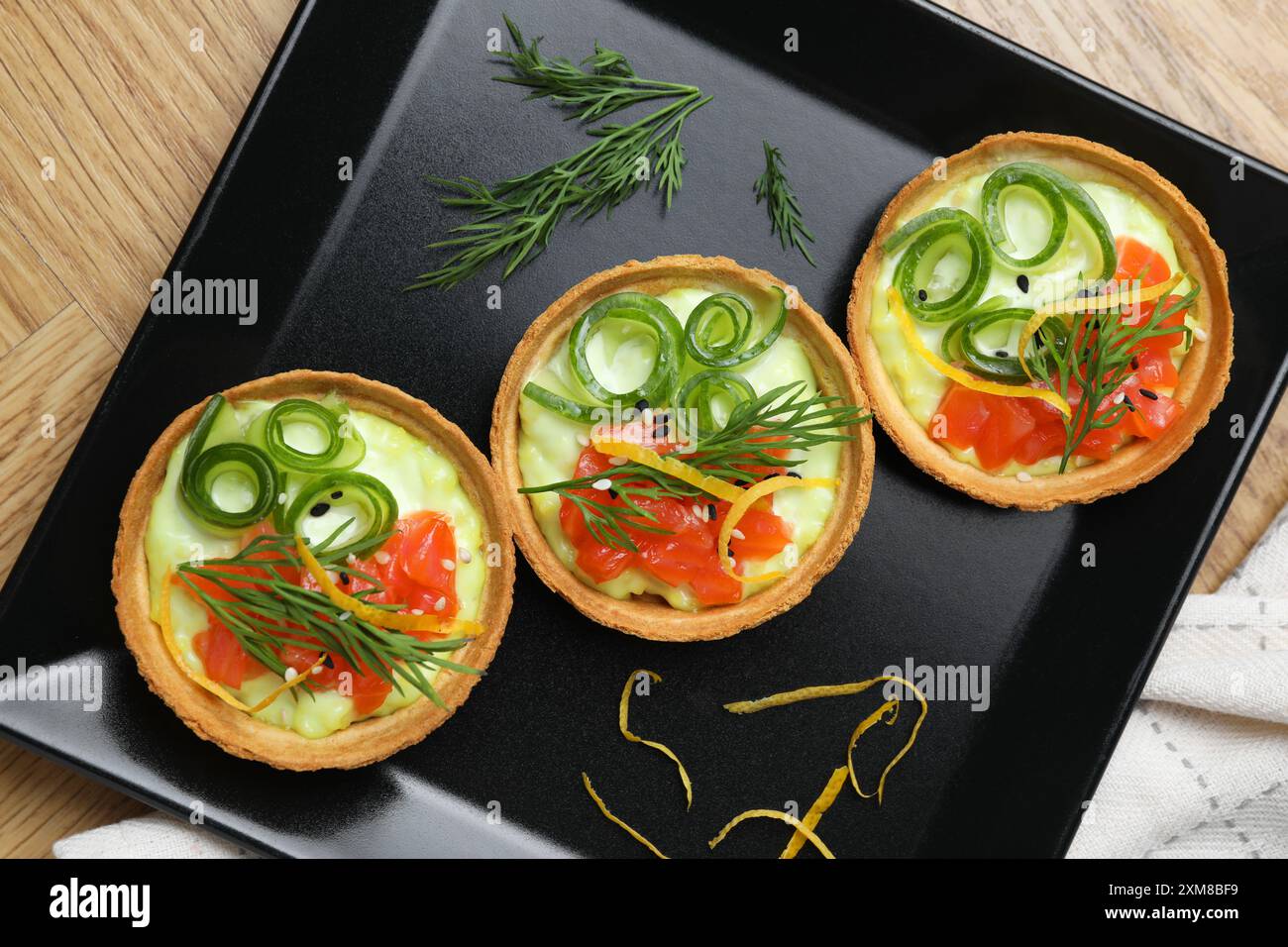 Delicious canapes with salmon on wooden table, top view Stock Photo - Alamy