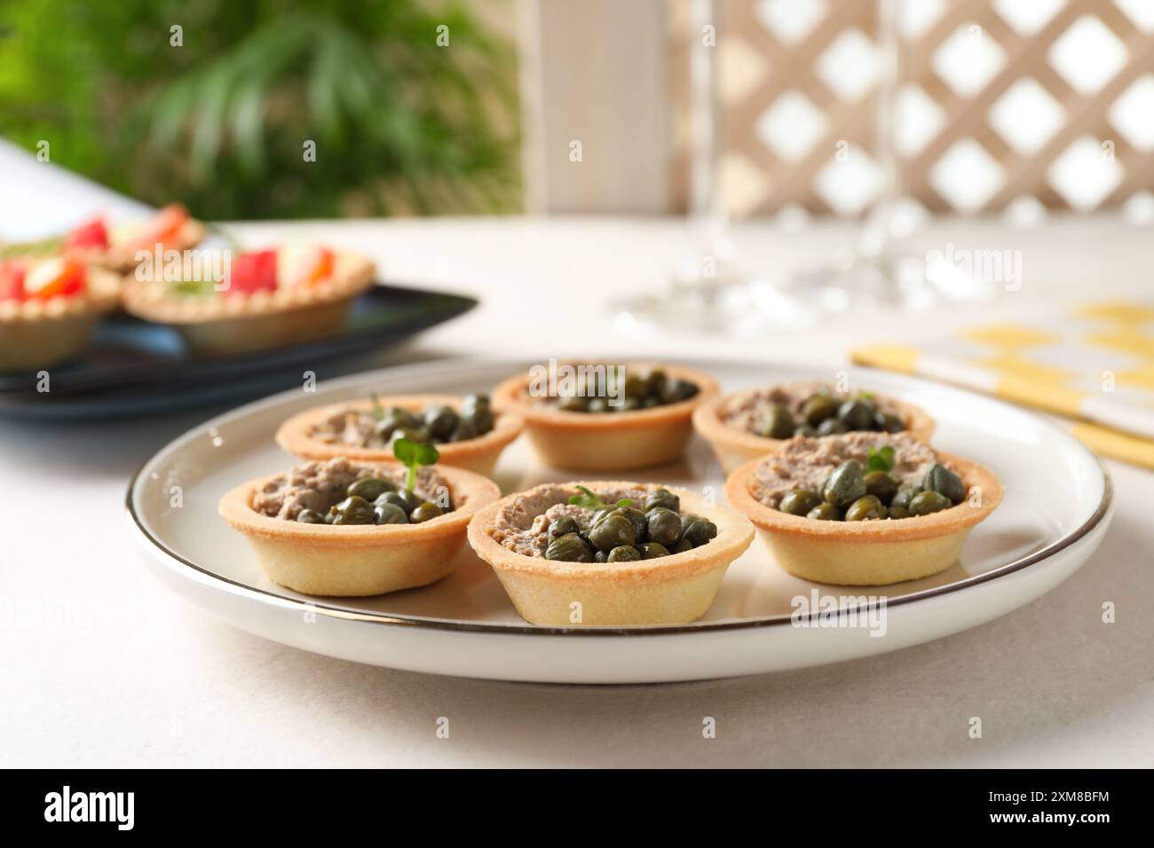 Delicious canapes with pate and capers on white table Stock Photo - Alamy