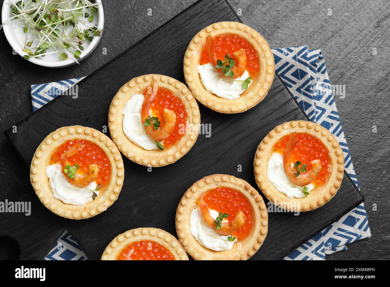Delicious canapes with shrimps, red caviar and cream cheese on dark ...
