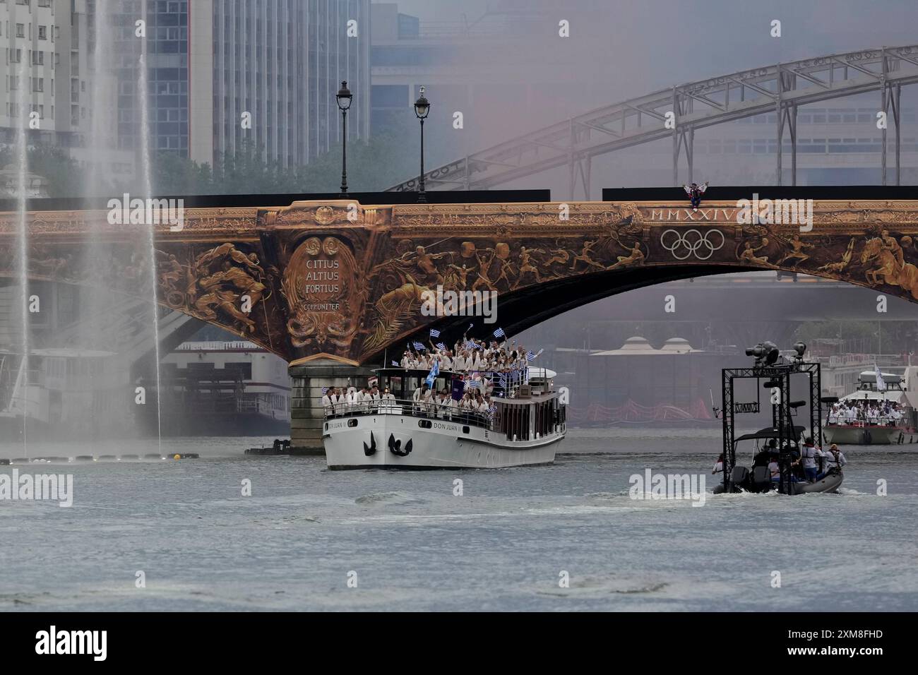 Team Greece's boat parades along the Seine river in Paris, France ...