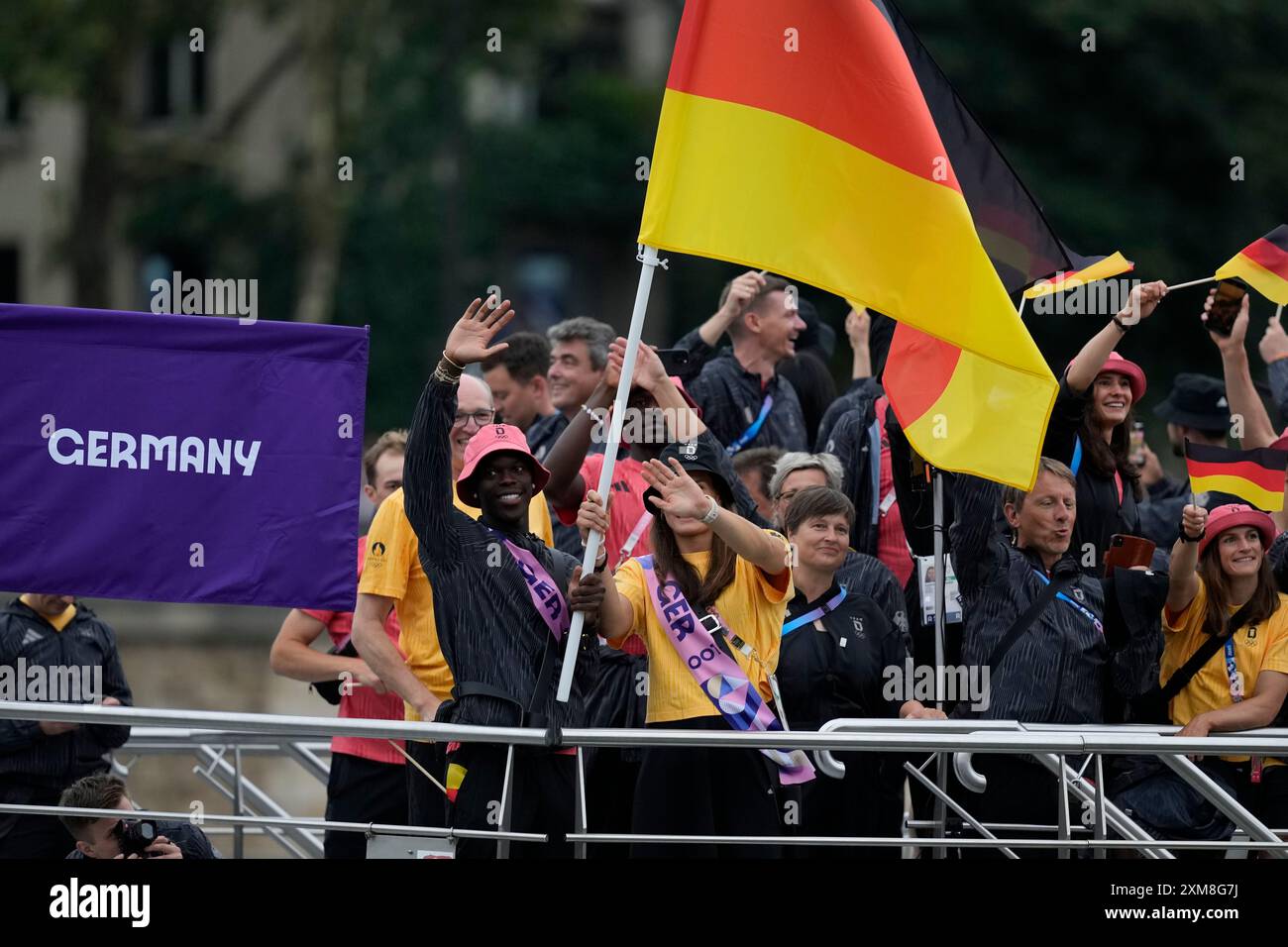 Germany's Dennis Schroder and Anna-Maria Wagner hold the German flag as ...
